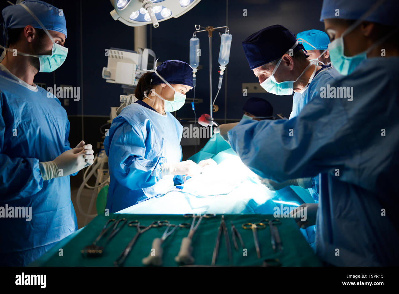 Team of surgeons over operating table during serious operation Stock ...