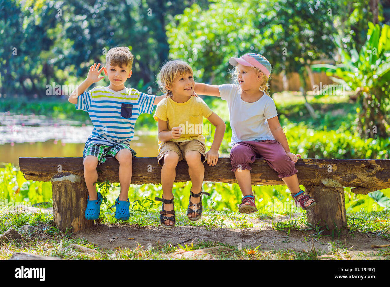 Children rest during a hike in the woods Stock Photo - Alamy