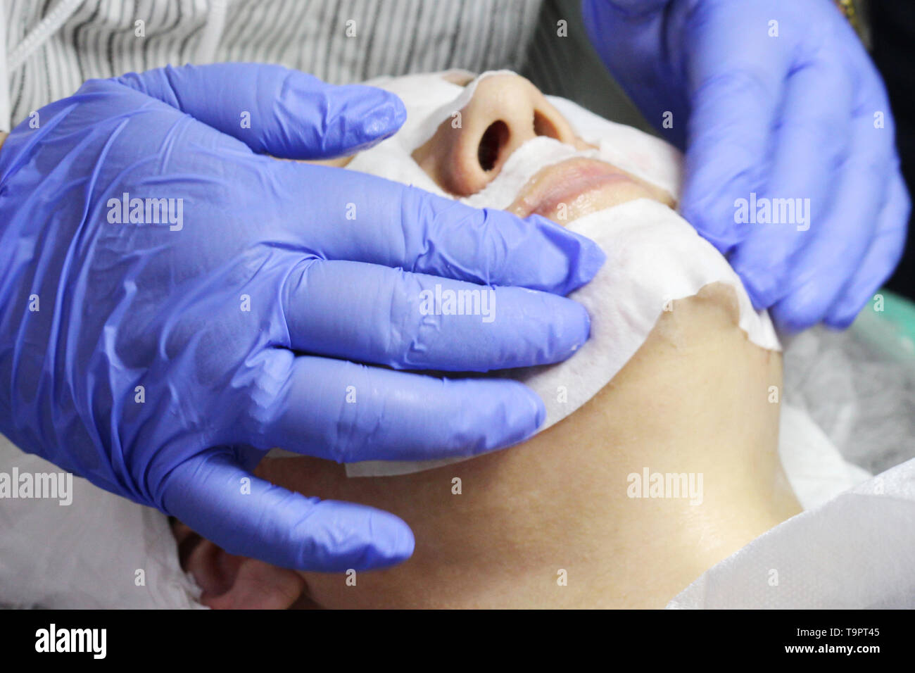 Removing the mask hi-res stock photography and images - Alamy