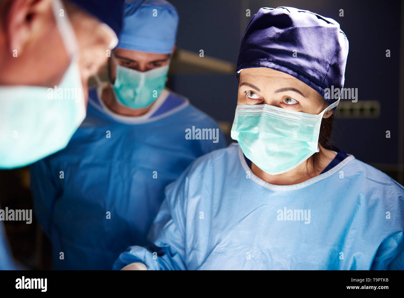 Surgeon during a very important operation in dark operating room Stock ...
