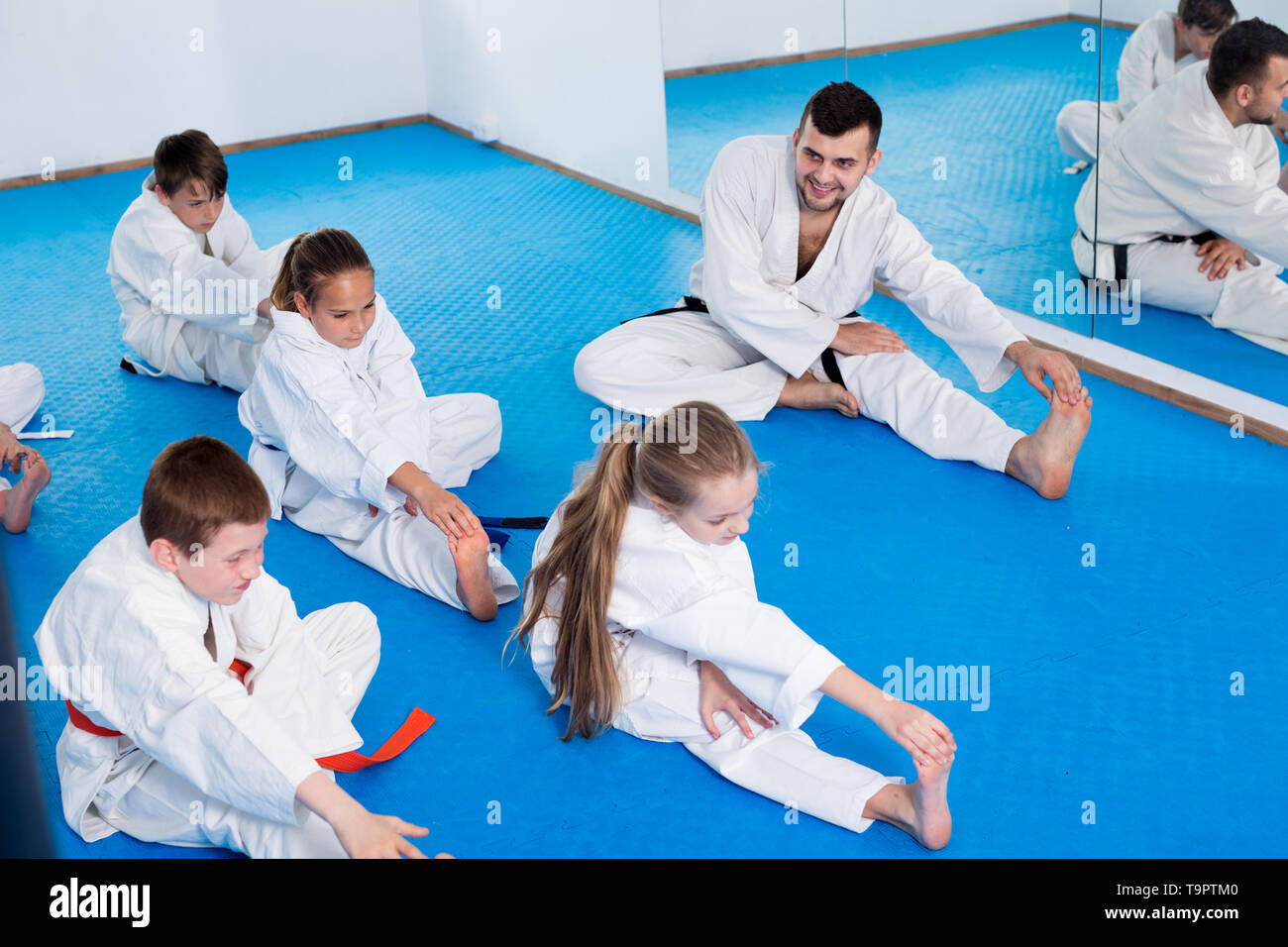 Happy children getting ready and stretching for karate class Stock ...