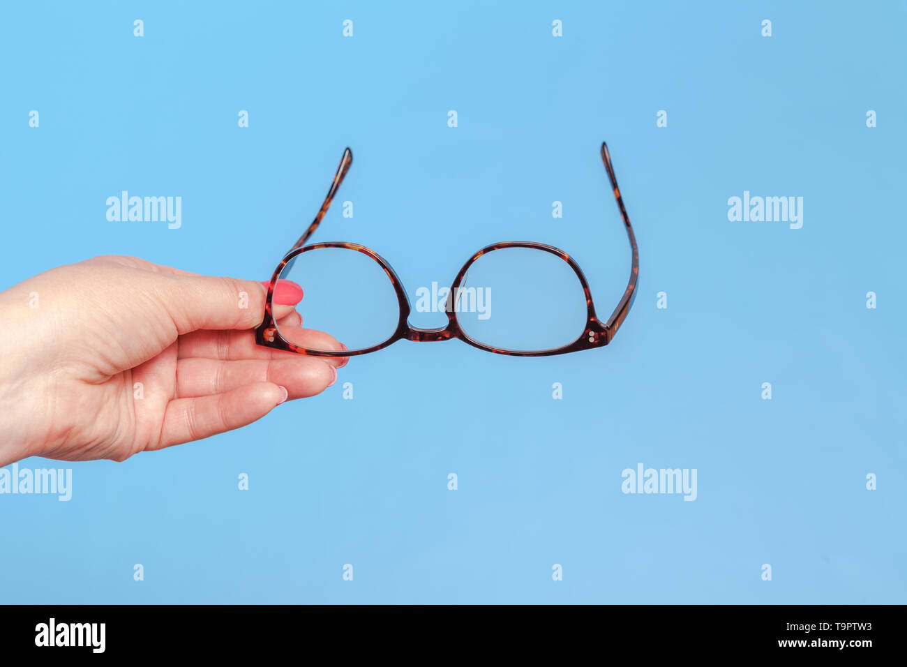 Hands holding glasses eye test hi-res stock photography and images - Alamy
