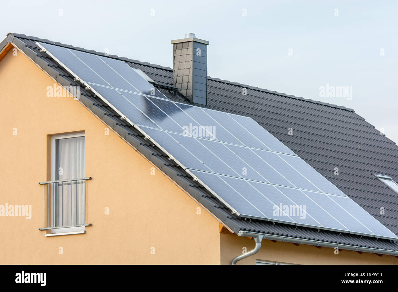 Photovoltaic system on residential building seen from a public road ...