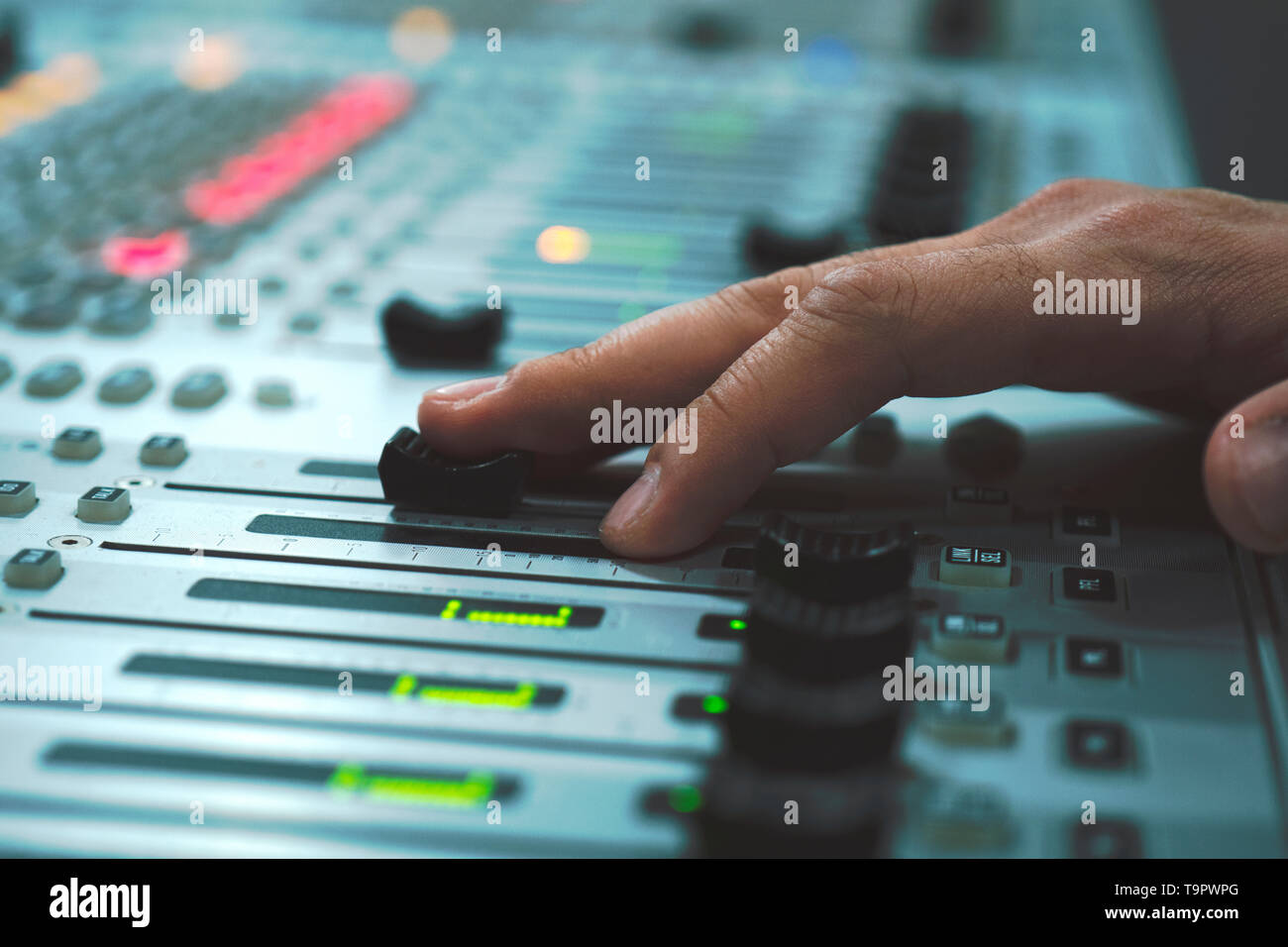 Professional audio mixing console with faders and adjusting knobs ...
