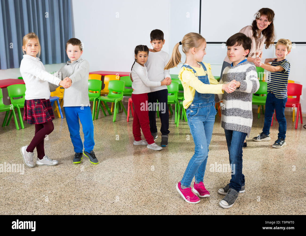 Happy laughing pupils of primary school having fun during break with ...