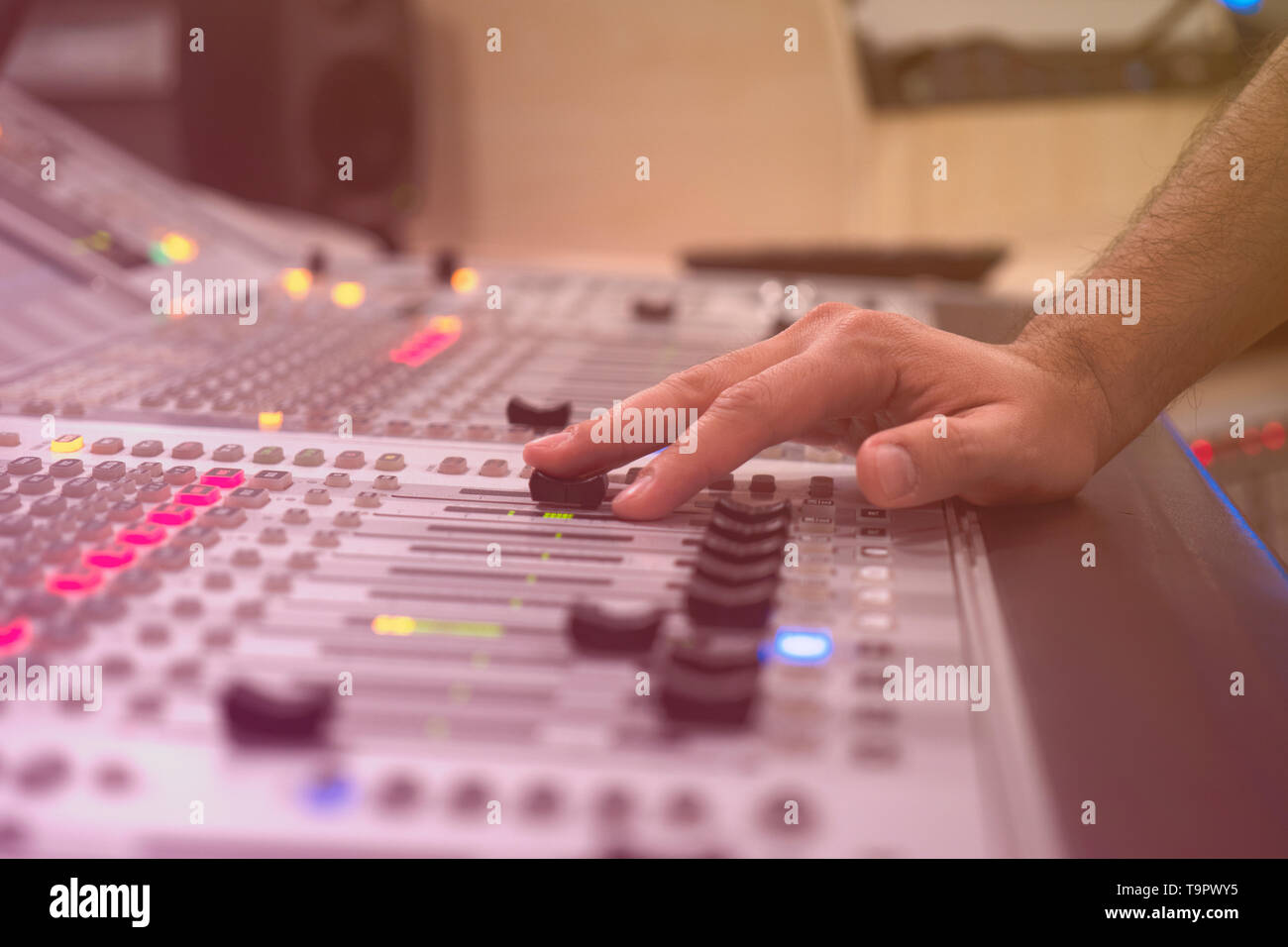 Professional audio mixing console with faders and adjusting knobs ...