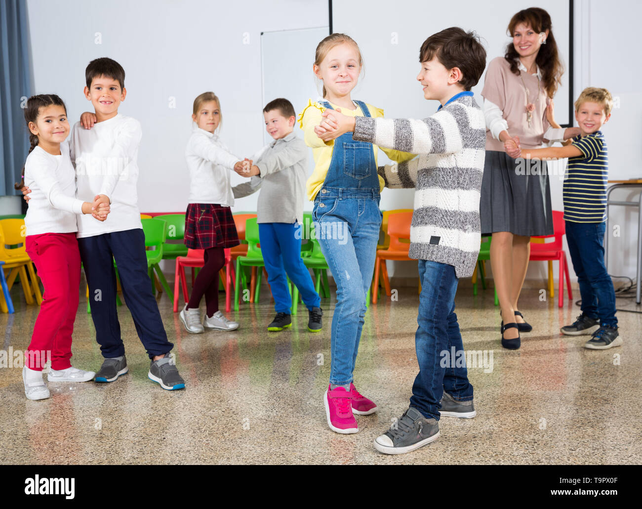 Happy laughing pupils of primary school having fun during break with ...