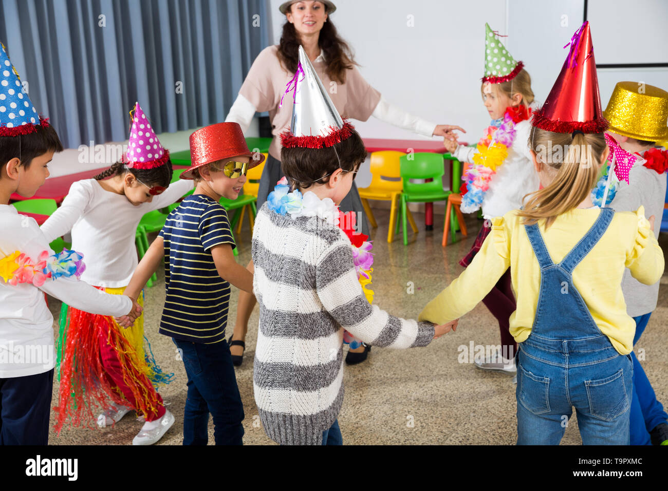 Happy laughing pupils of primary school having fun during festive event ...