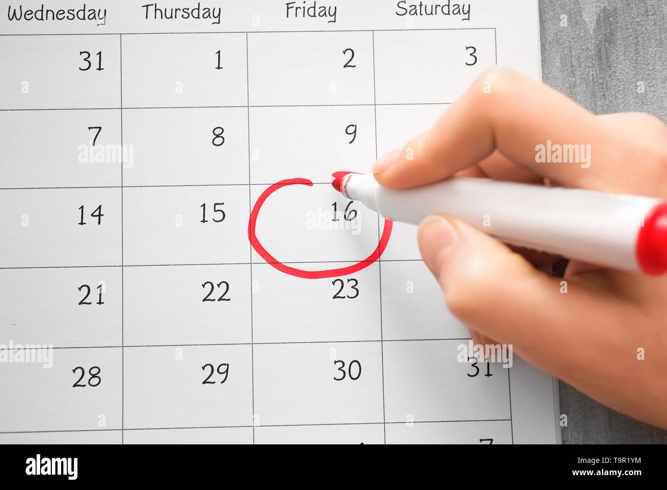 Female hand encircling date in calendar, closeup Stock Photo - Alamy