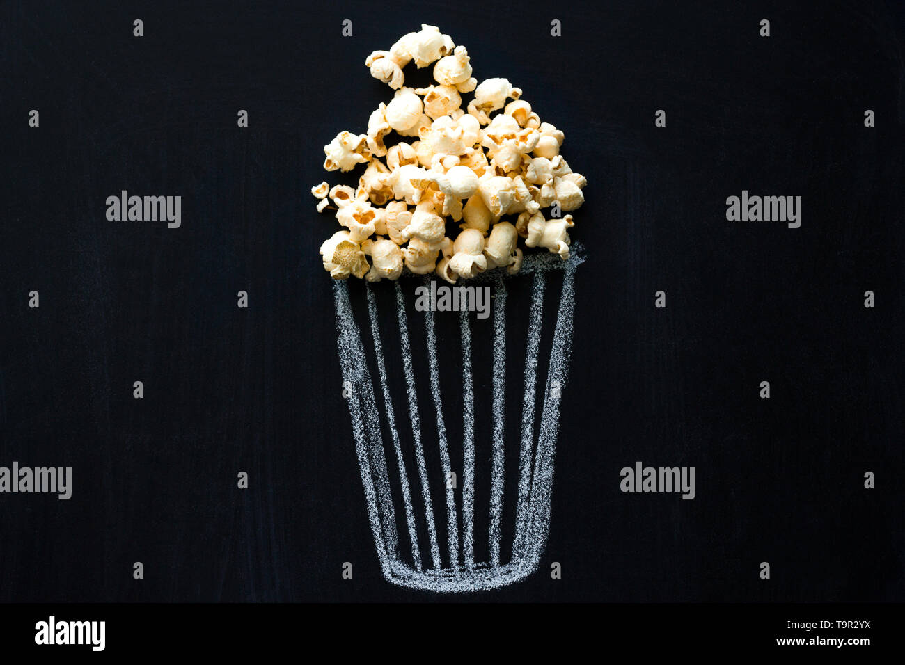 pop corn bucket on a blackboard Stock Photo - Alamy