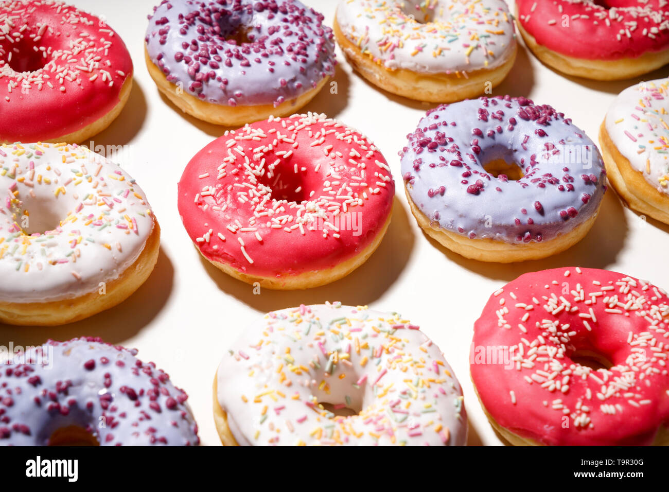 Tasty doughnuts on white background Stock Photo - Alamy