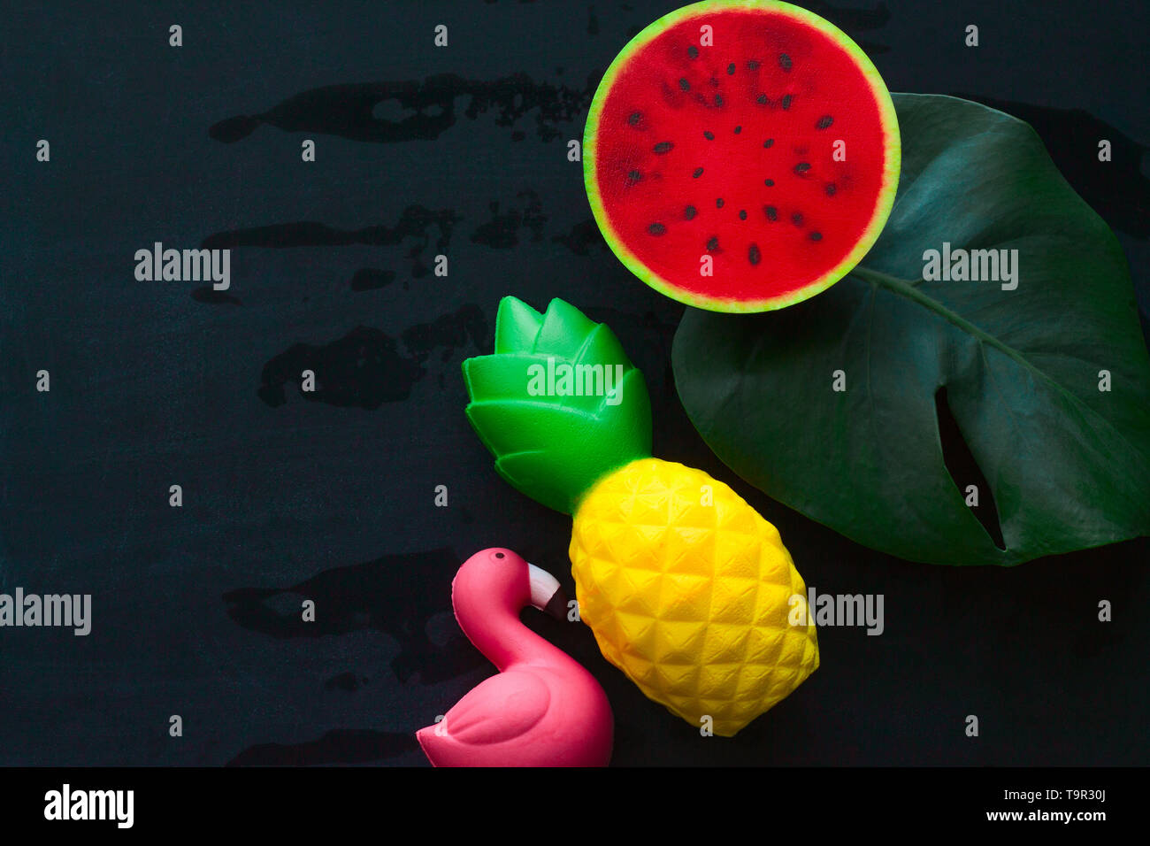 top view monstera green leaf ,flamingo ,pineapple and watermelon ...