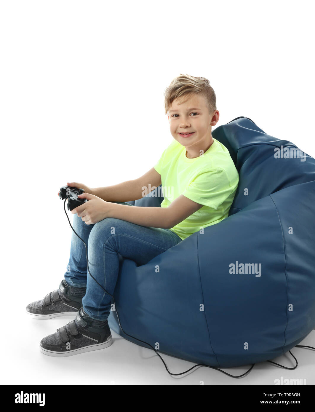 Cute boy playing video game on white background Stock Photo - Alamy