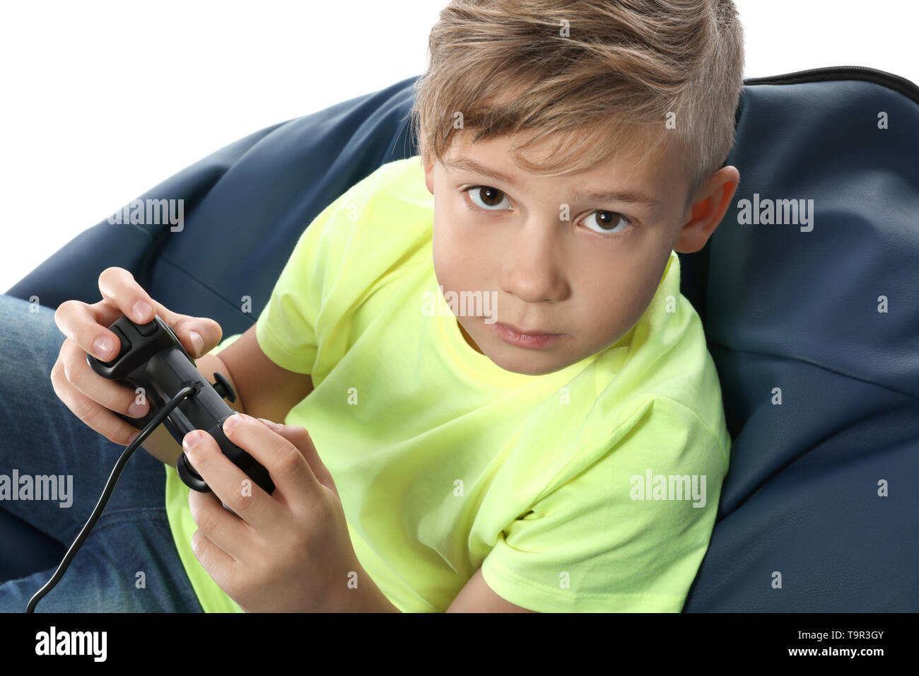 Cute boy playing video game on white background Stock Photo - Alamy