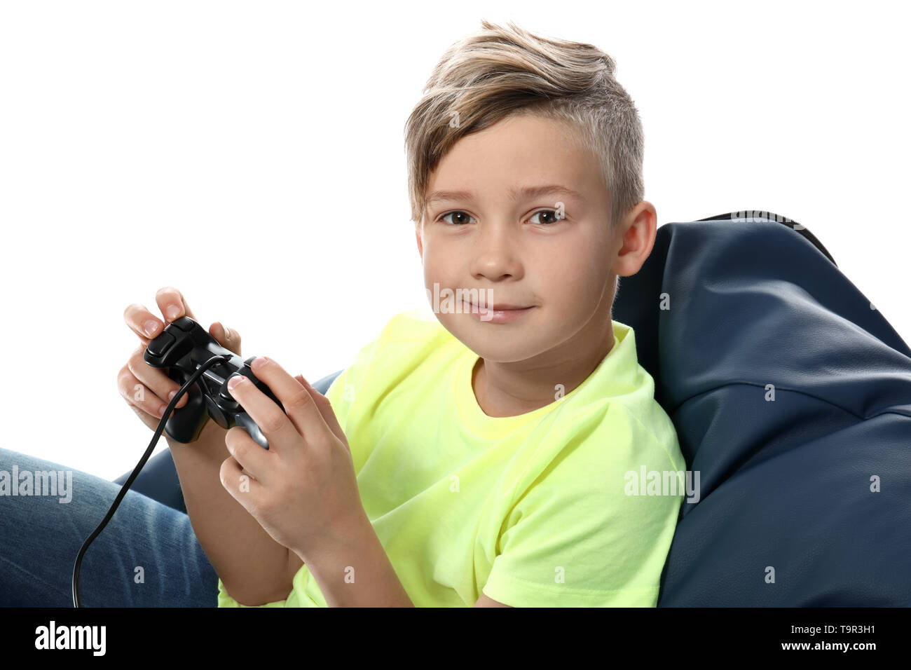 Cute boy playing video game on white background Stock Photo - Alamy