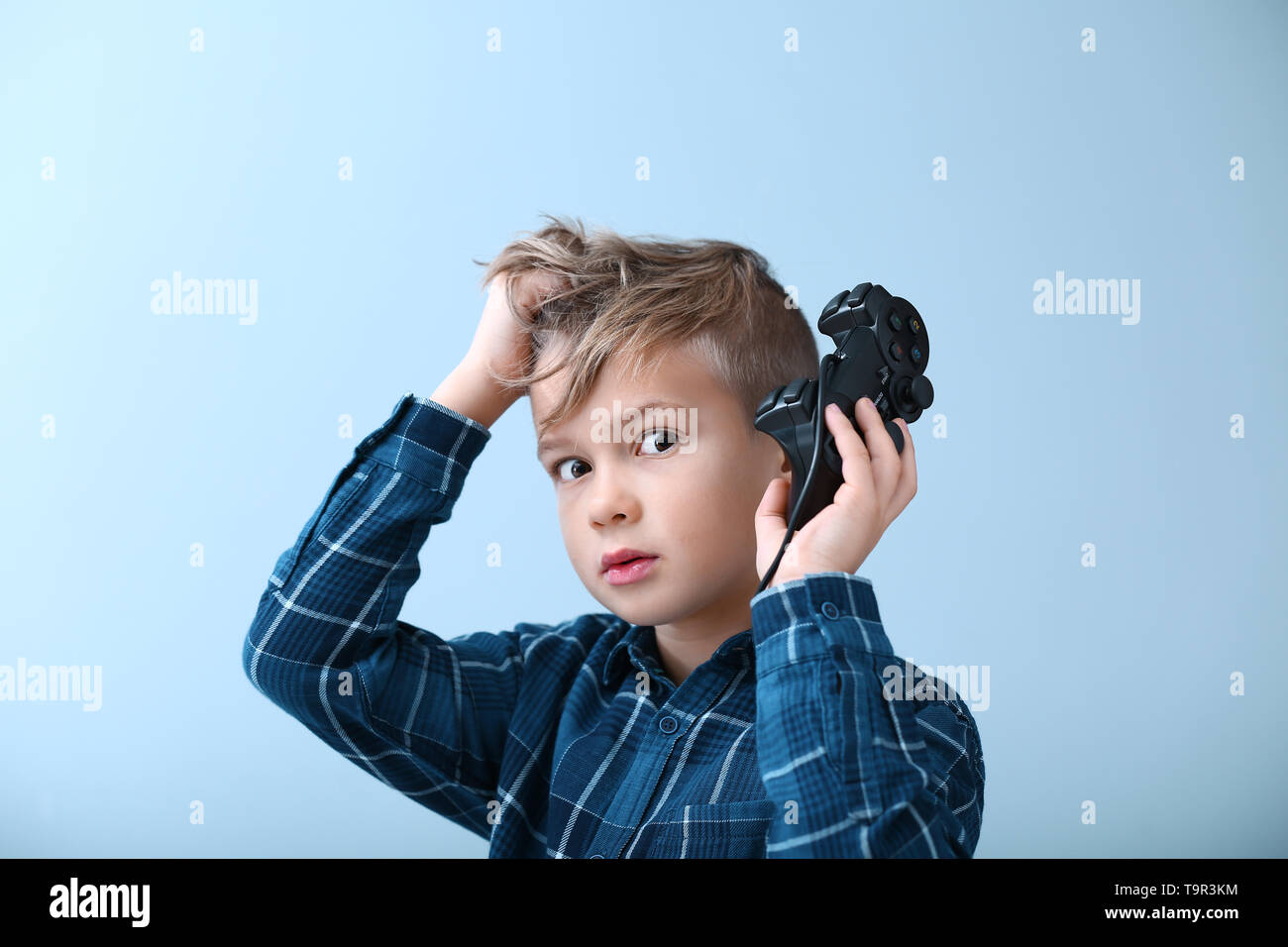Emotional boy after losing video game on color background Stock Photo ...