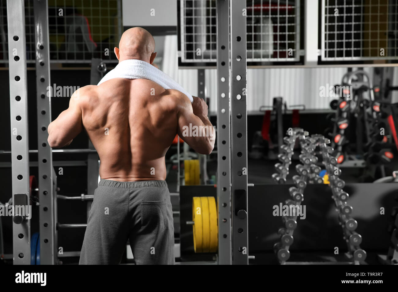 Strong muscular man in gym Stock Photo - Alamy