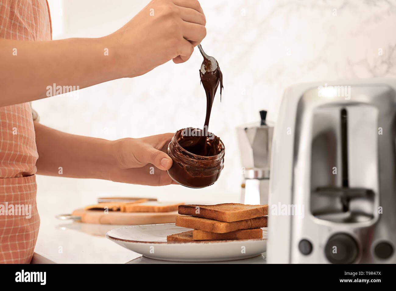 Woman preparing toasts for breakfast in kitchen Stock Photo - Alamy