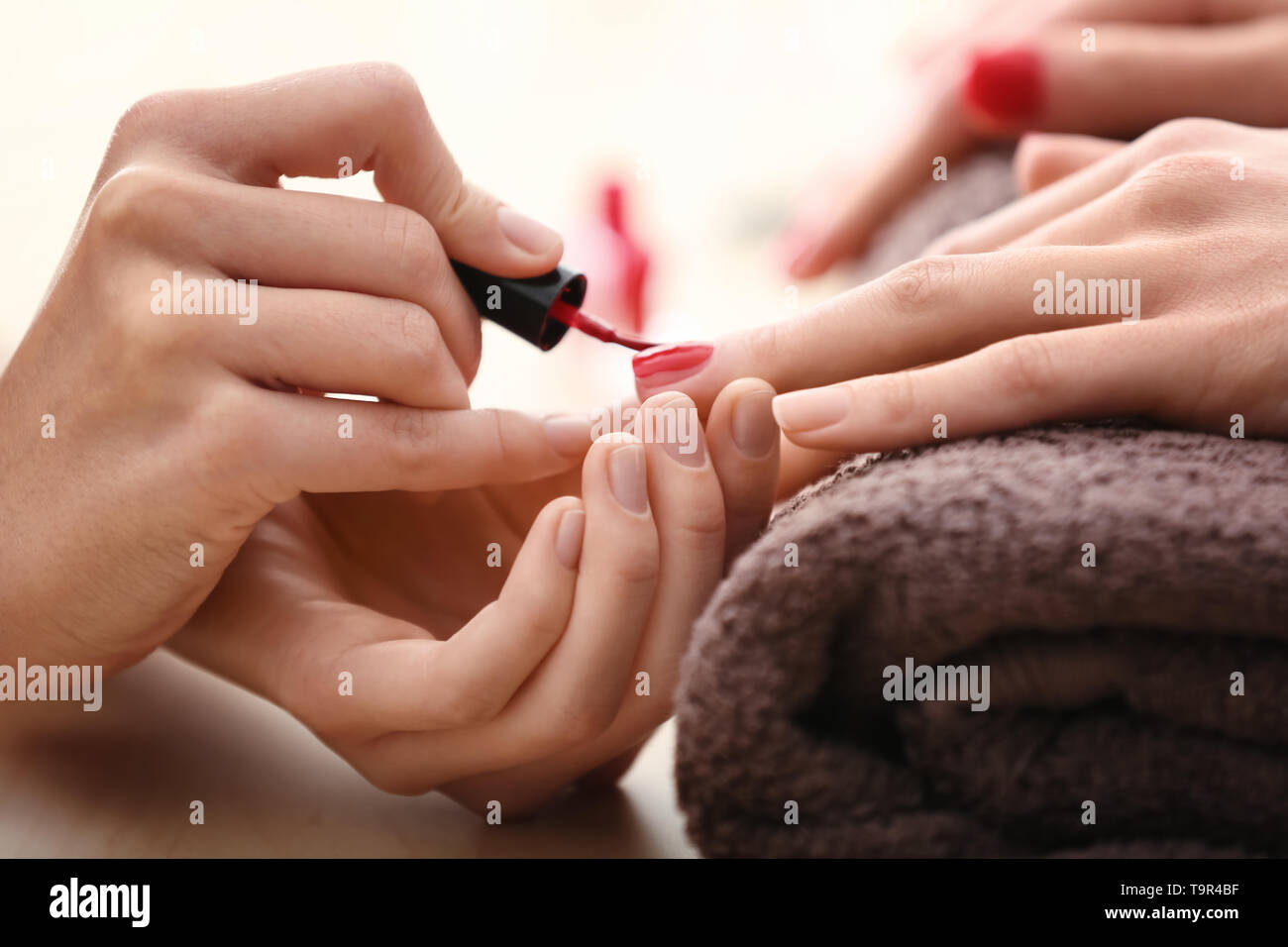 Young woman getting manicure in beauty salon Stock Photo - Alamy