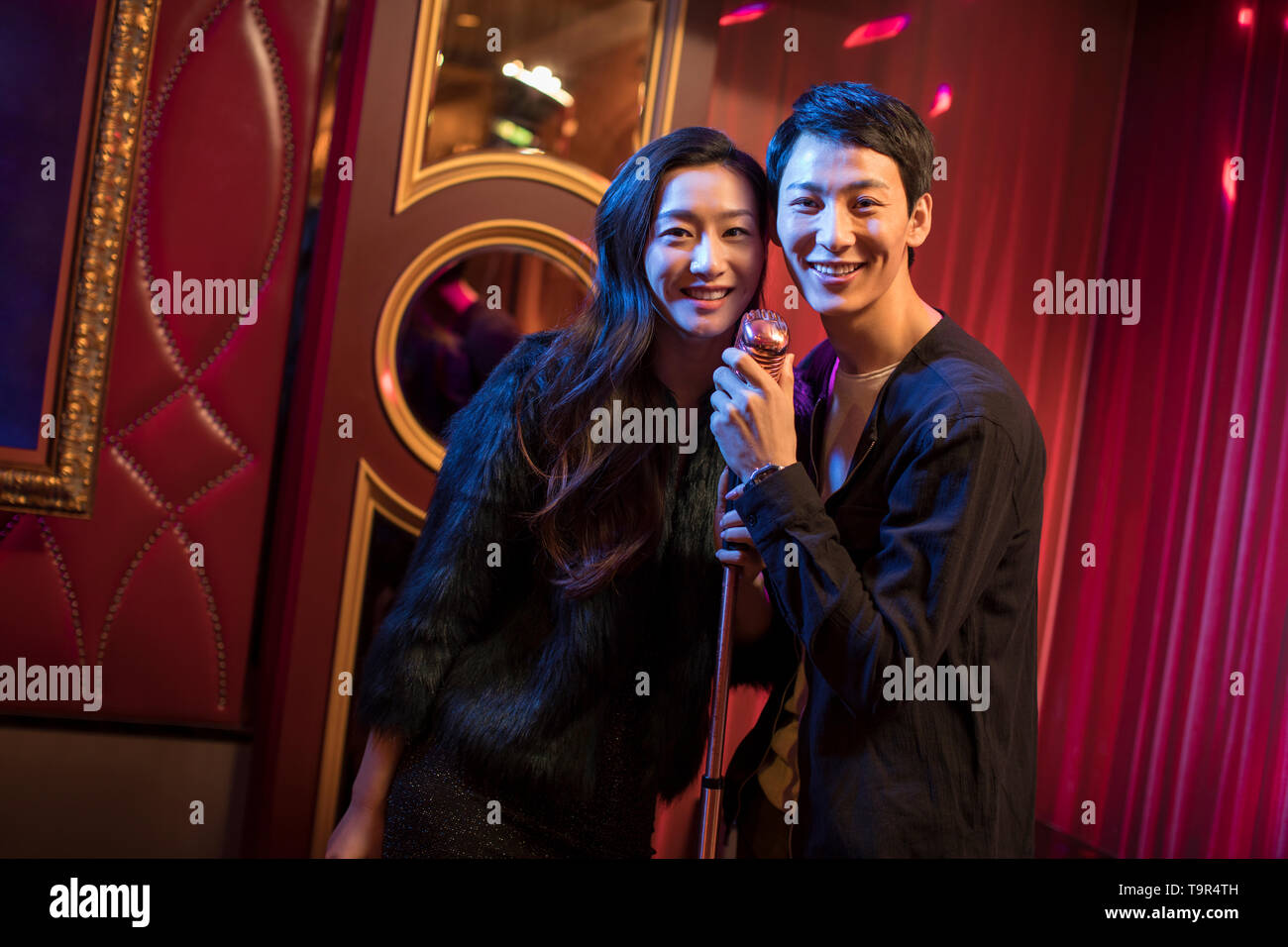 Two women singing karaoke hi-res stock photography and images - Alamy