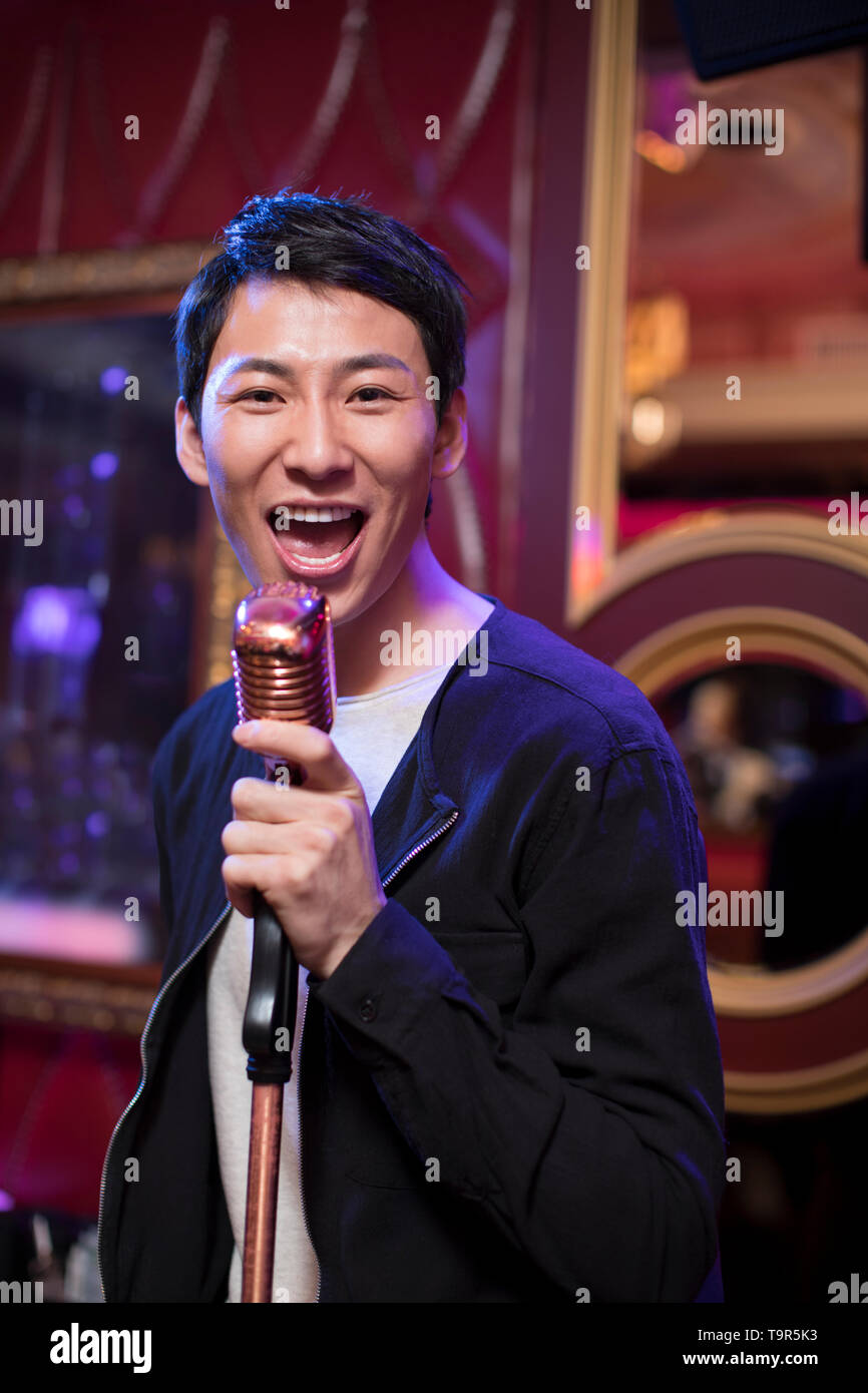 Asian man singing in karaoke hi-res stock photography and images - Alamy