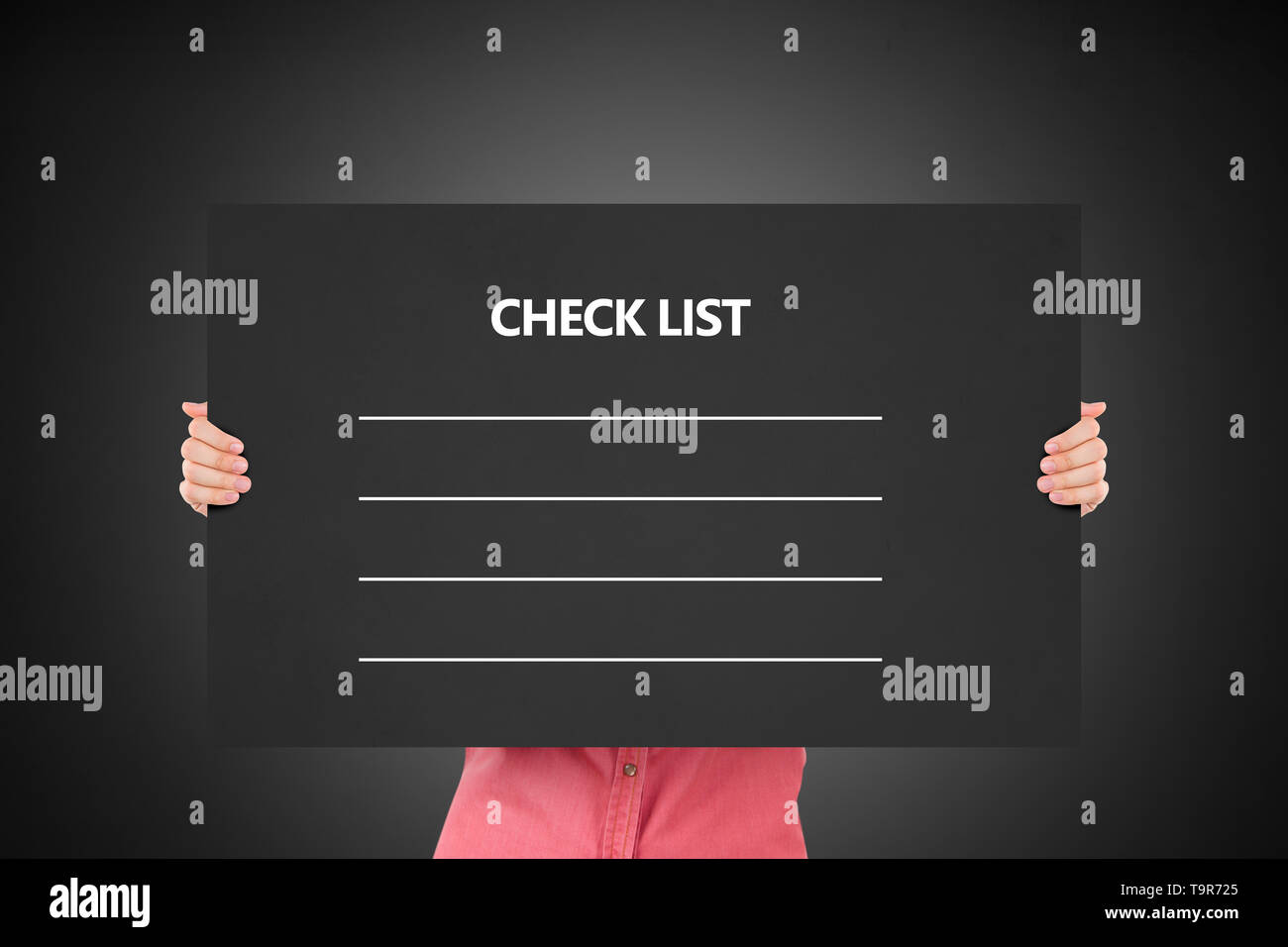 Hand holding check list sign with copy space for your text on black ...