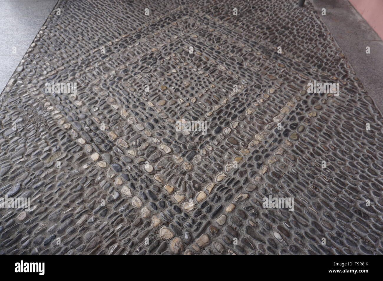 old cobblestone plaza with geometric pattern designs Stock Photo - Alamy