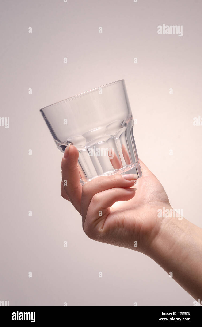hand holding a glass on a white background. isolate Stock Photo - Alamy