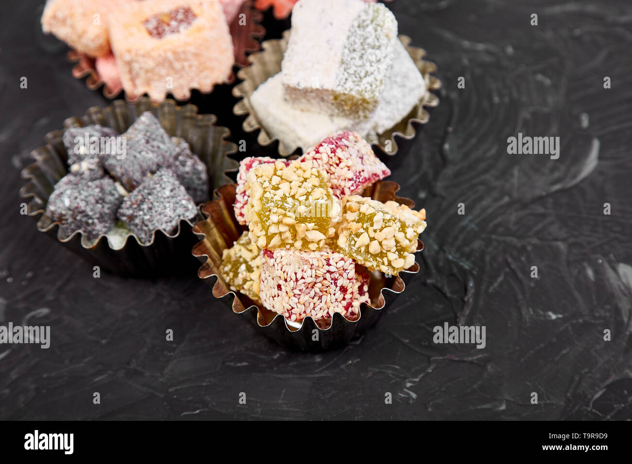 Set of various Turkish delight om black background. Top view. Flat lay ...