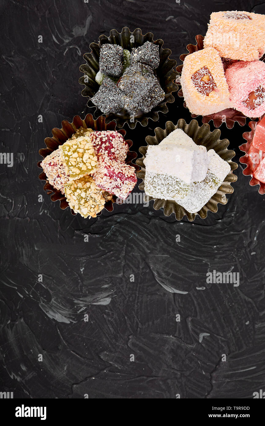 Set of various Turkish delight om black background. Top view. Flat lay ...