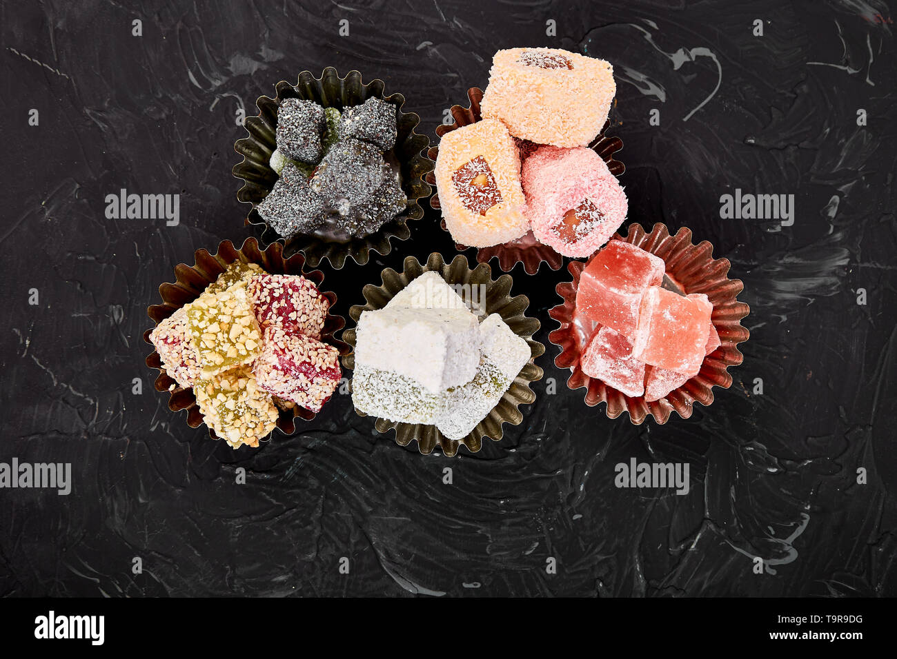Set of various Turkish delight om black background. Top view. Flat lay ...