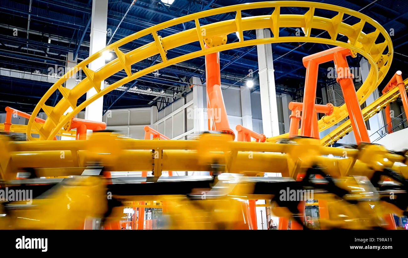 Image of people riding in cart on the roller coaster in amusement park ...