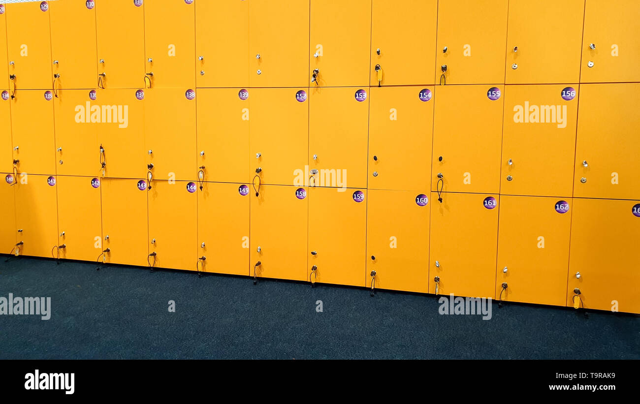 Closeup image of yellow lockers in the dressing room at gym Stock Photo ...