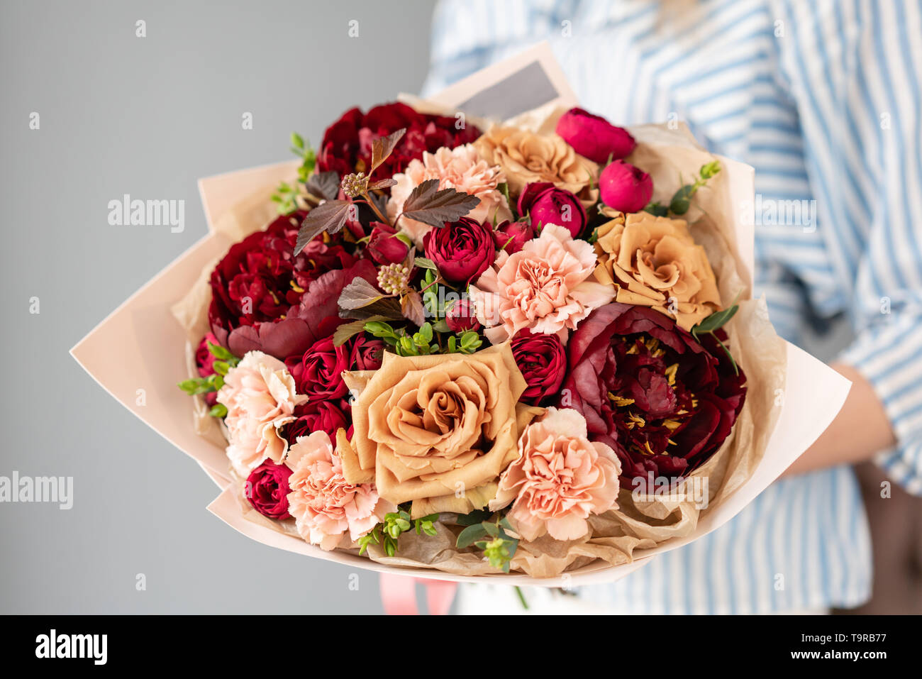 Beautiful bouquet of mixed flowers in woman hand. Floral shop concept ...