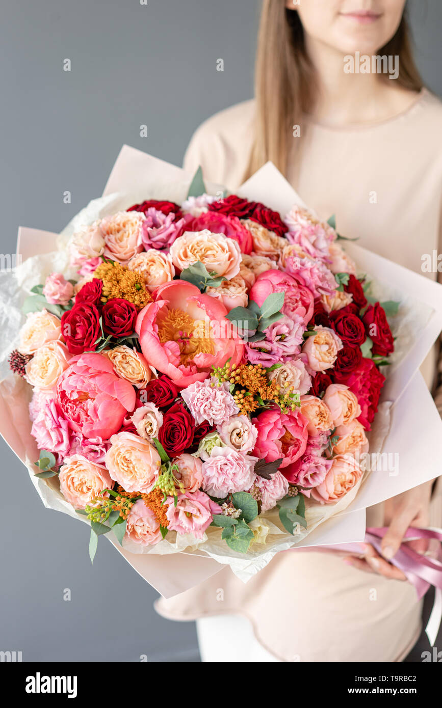 Large Beautiful bouquet of mixed flowers in woman hand. Floral shop ...