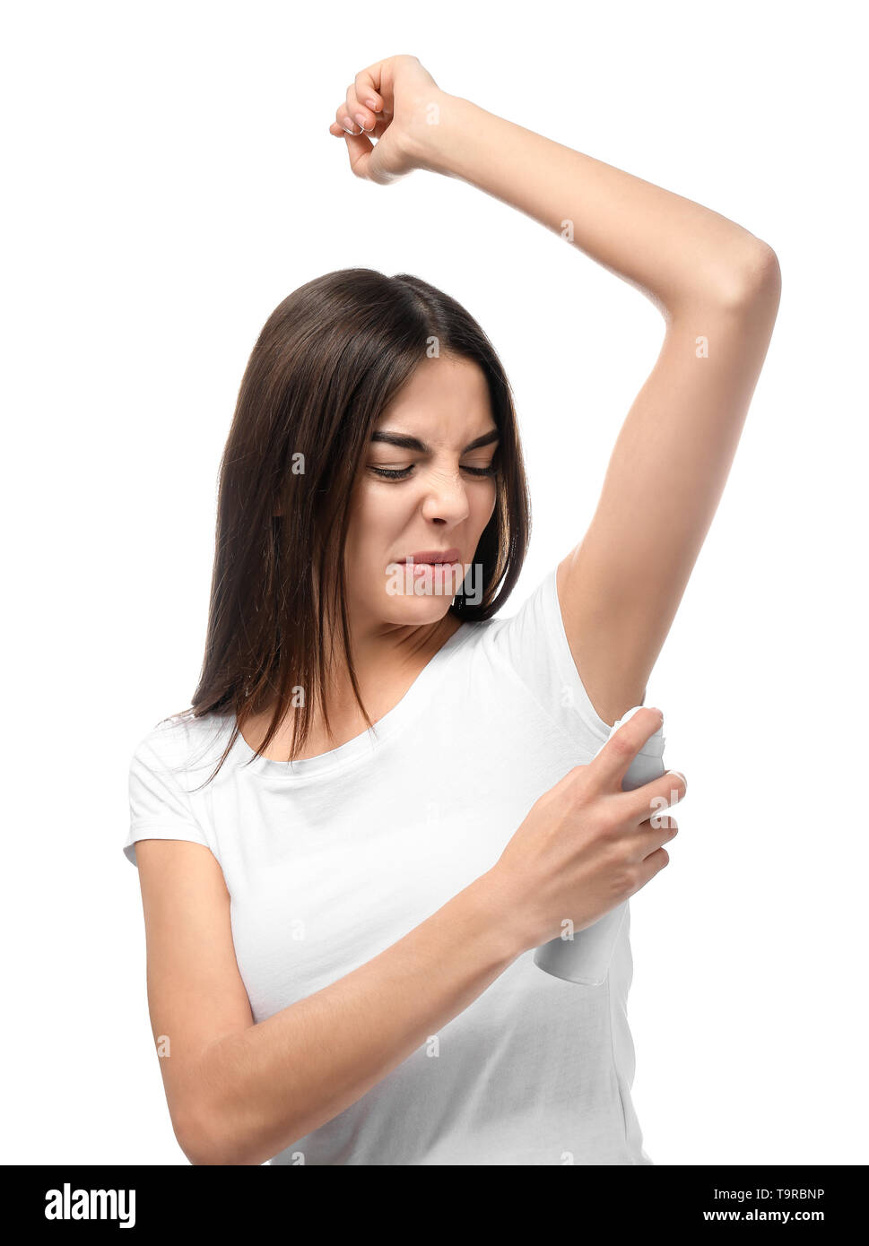 Beautiful young woman feeling smell of sweat on white background ...