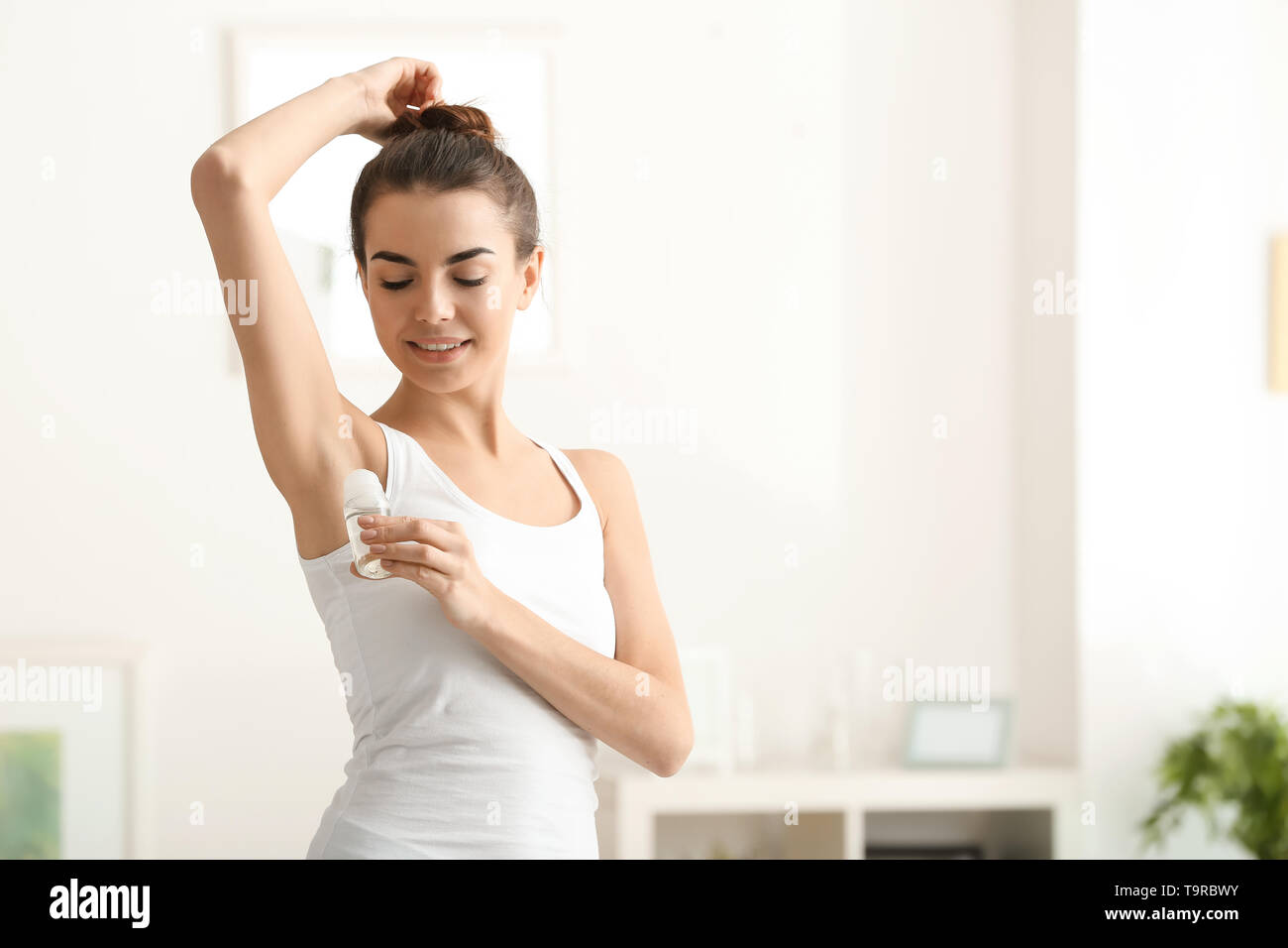 Woman using roll on deodorant hi-res stock photography and images - Alamy