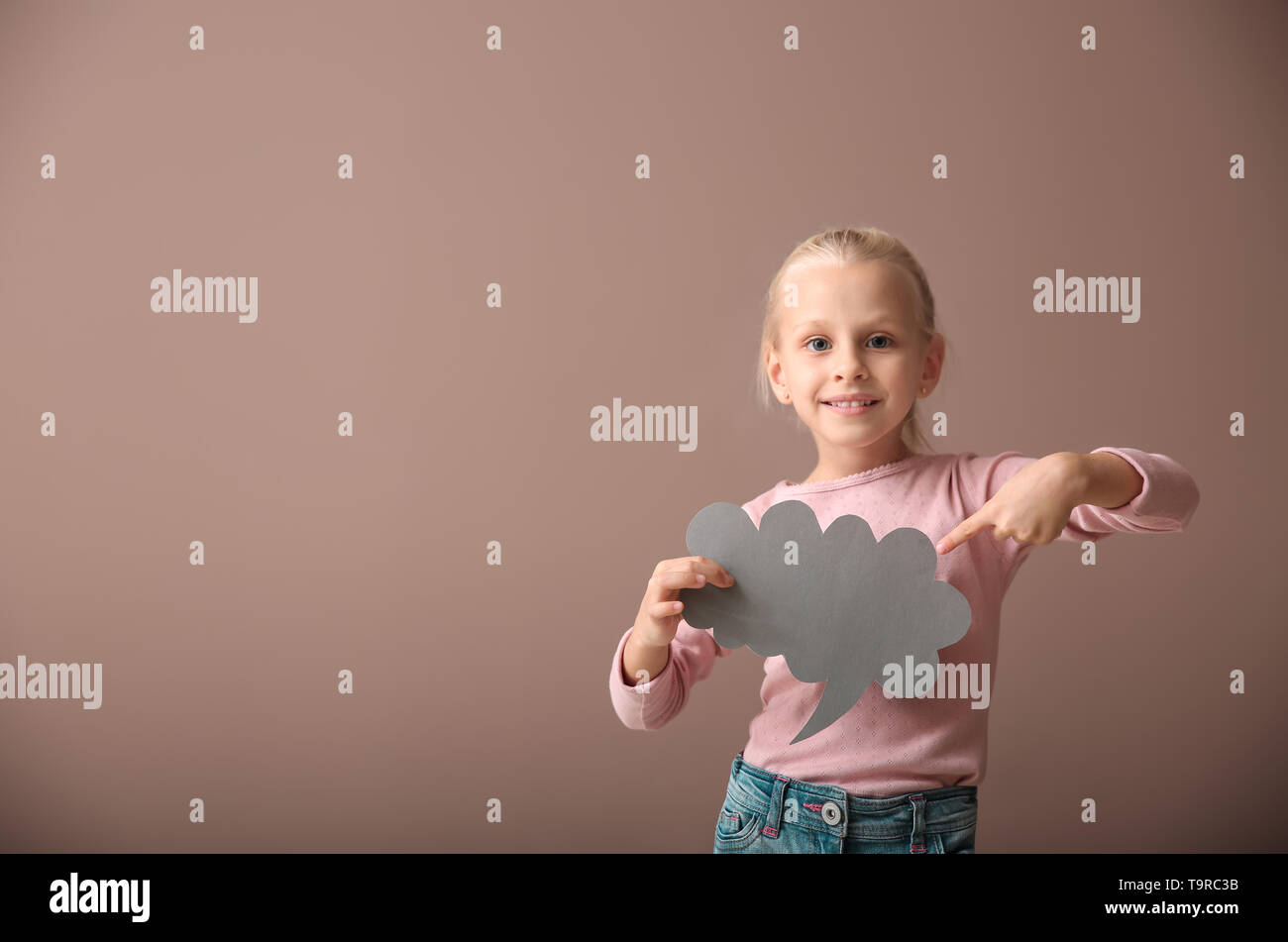 Little girl with blank speech bubble on color background Stock Photo ...