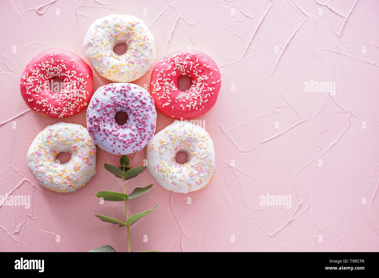Composition with tasty donuts on color background Stock Photo - Alamy