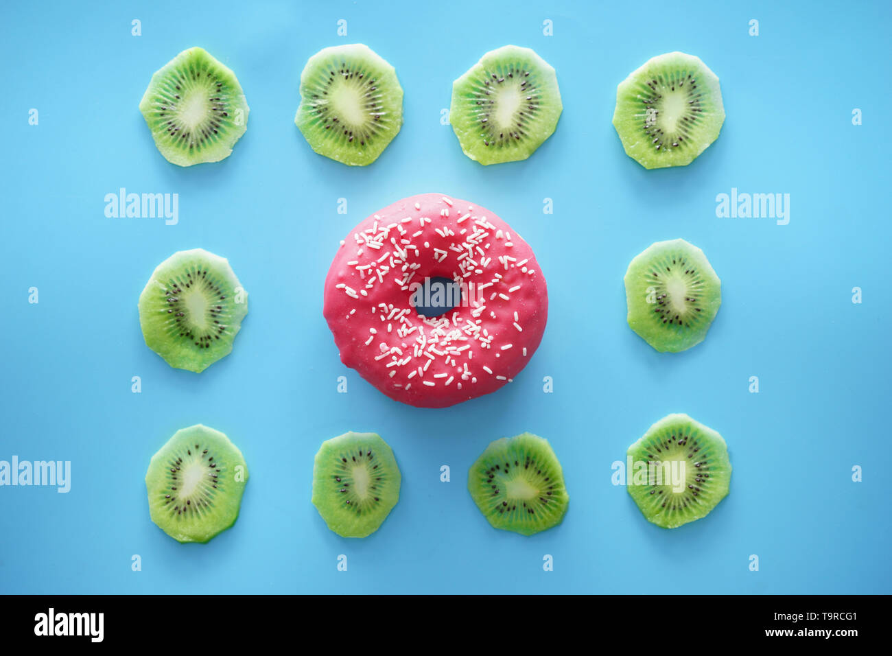 Tasty donut and kiwi slices on color background Stock Photo - Alamy