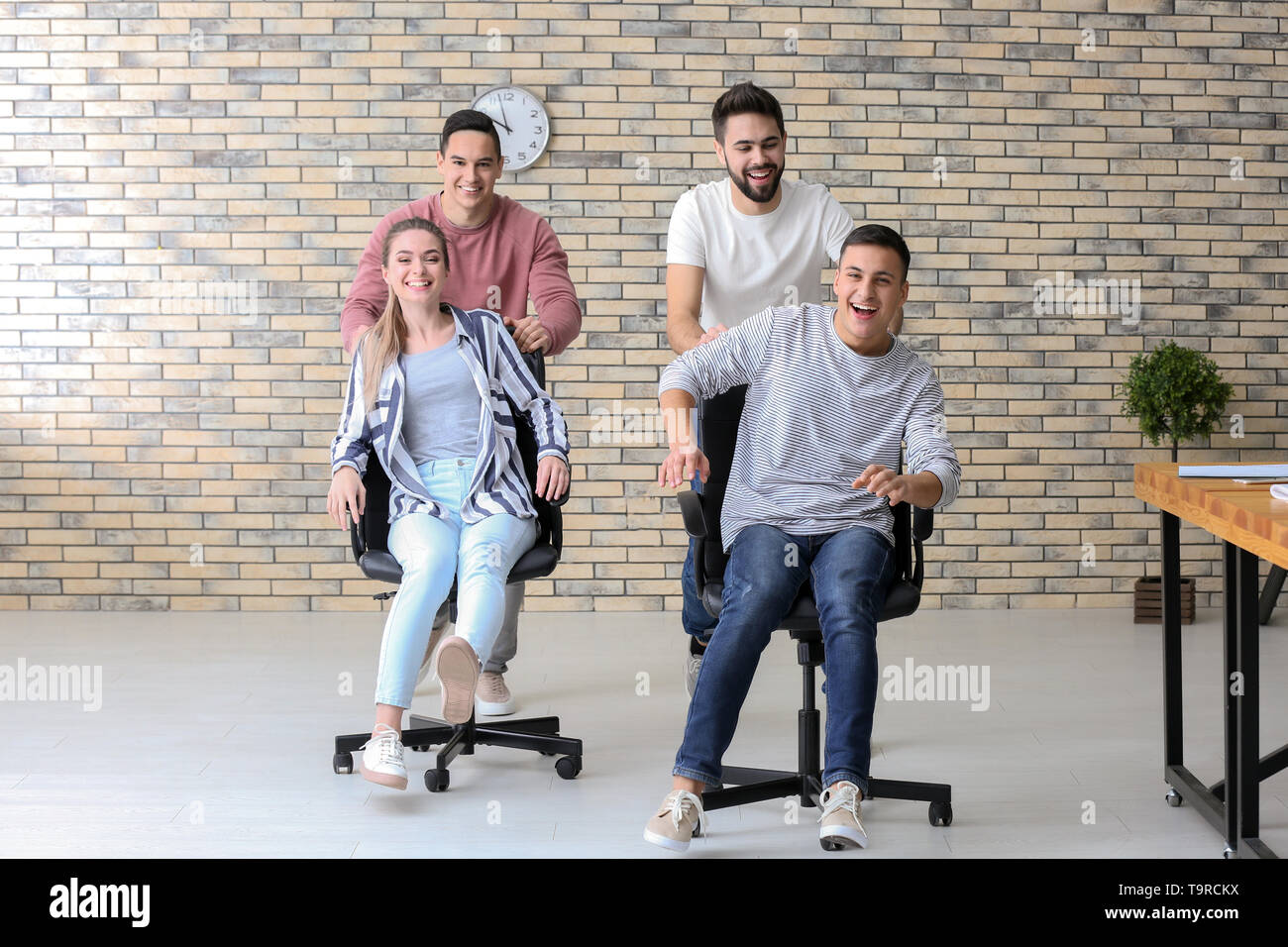 Young people having fun in office Stock Photo - Alamy