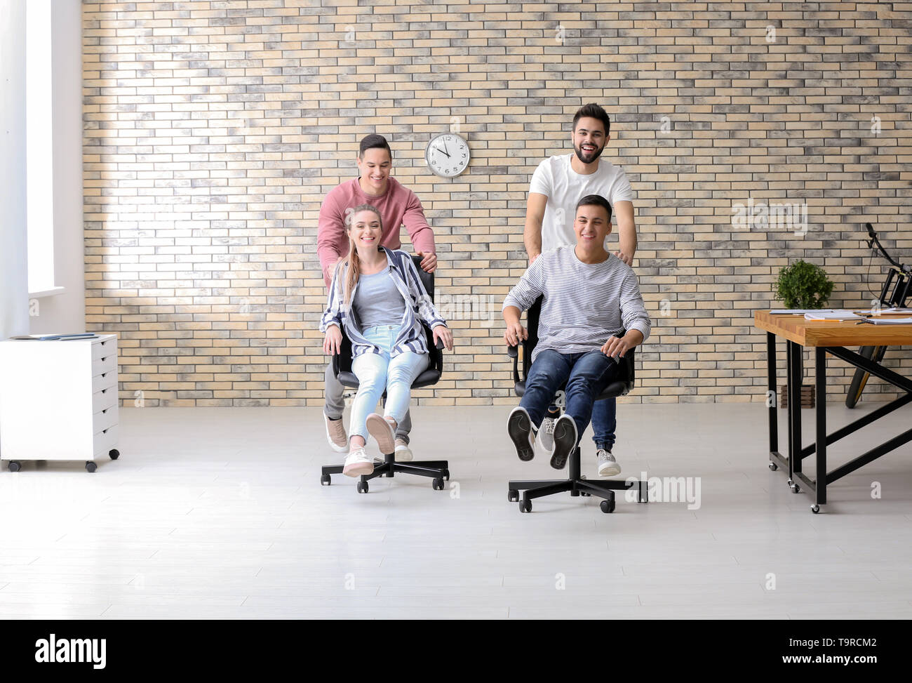 Young people having fun in office Stock Photo - Alamy