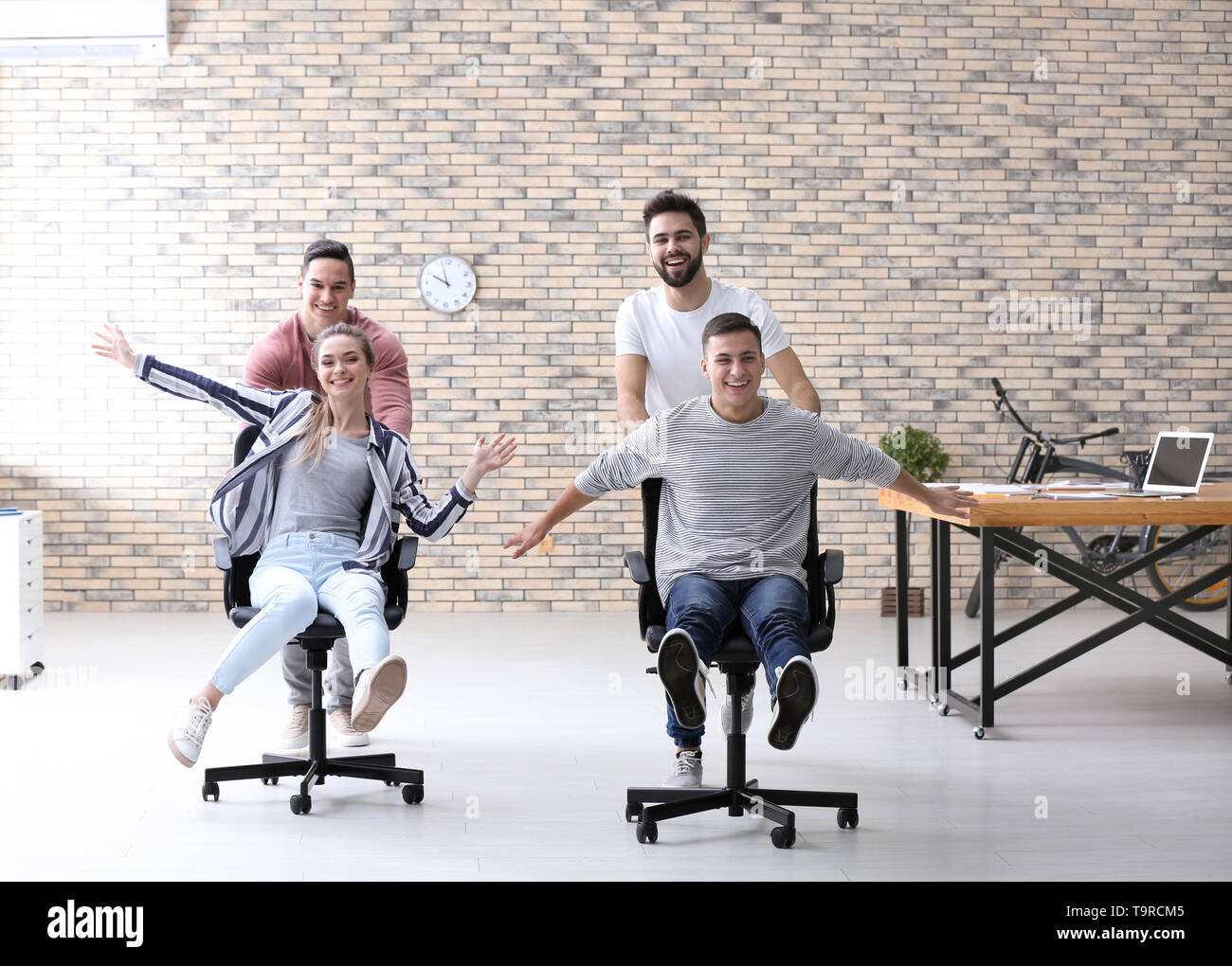 Young people having fun in office Stock Photo - Alamy