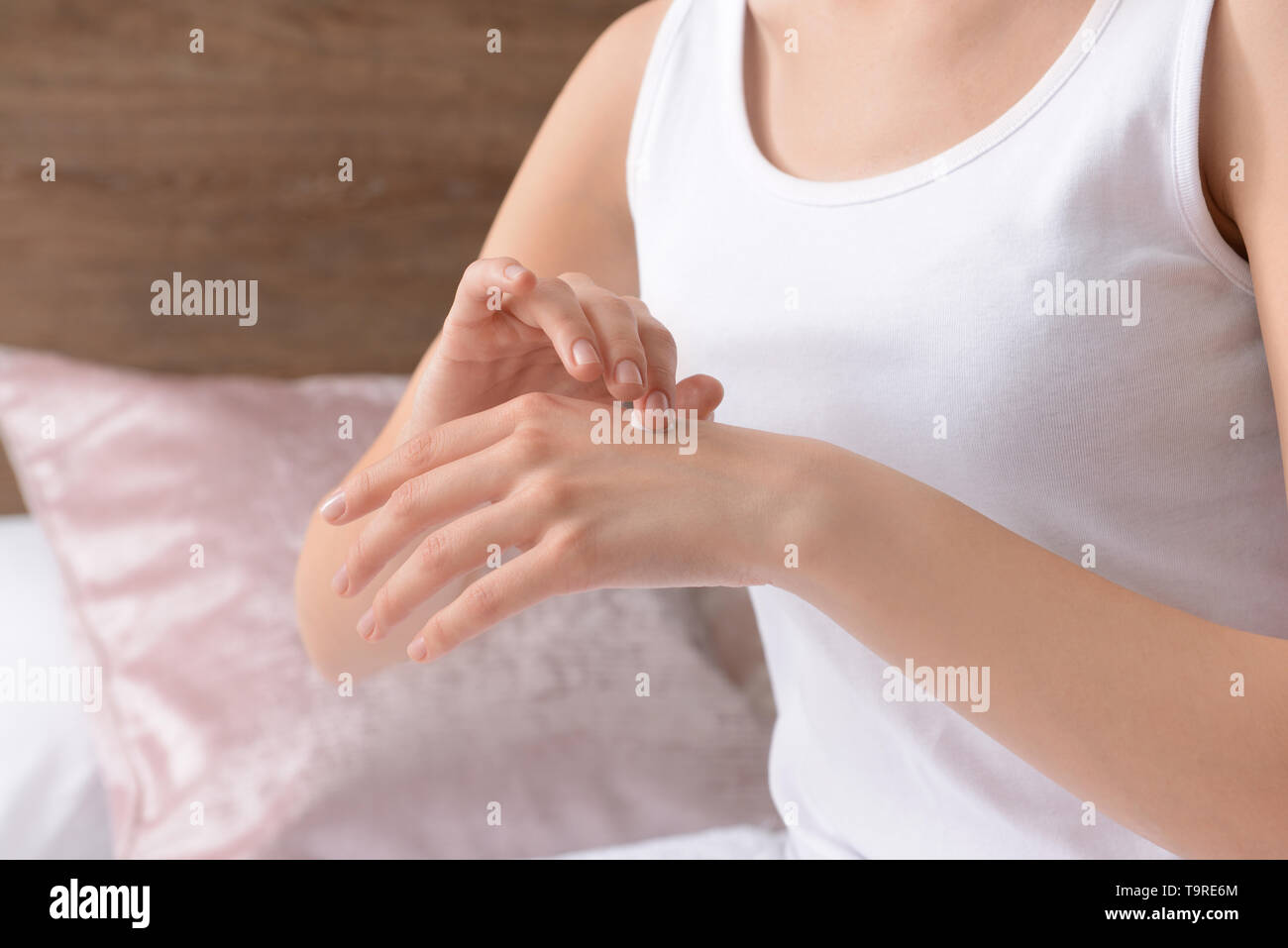 Woman applying hand cream at home Stock Photo - Alamy