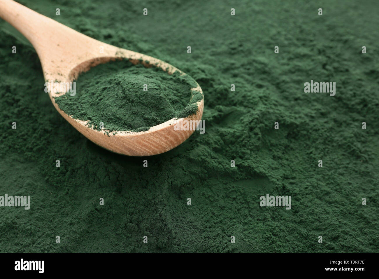 Wooden spoon on spirulina powder Stock Photo - Alamy