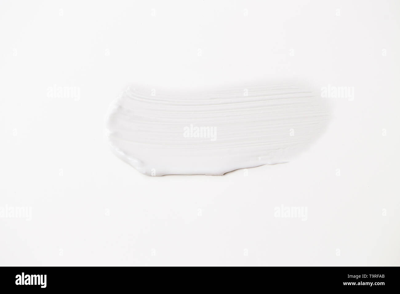 Sample of white cosmetic product isolated on white background. Smear of ...
