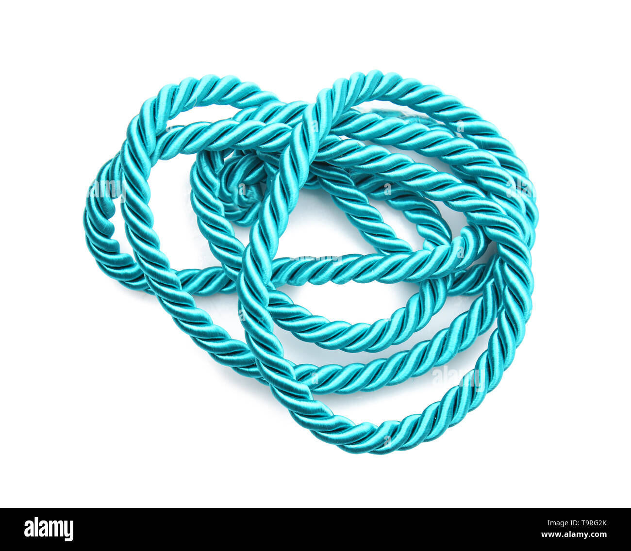 Rolled rope on white background Stock Photo - Alamy