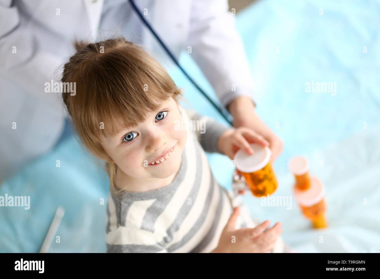 Cute little girl at doctor reception getting medications prescription ...