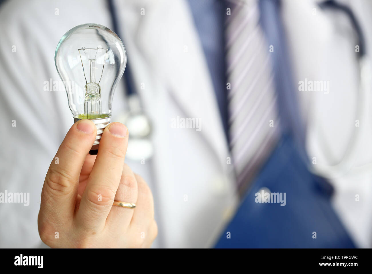 Male doctor hand holding lightbulb as bright idea invention symbol ...