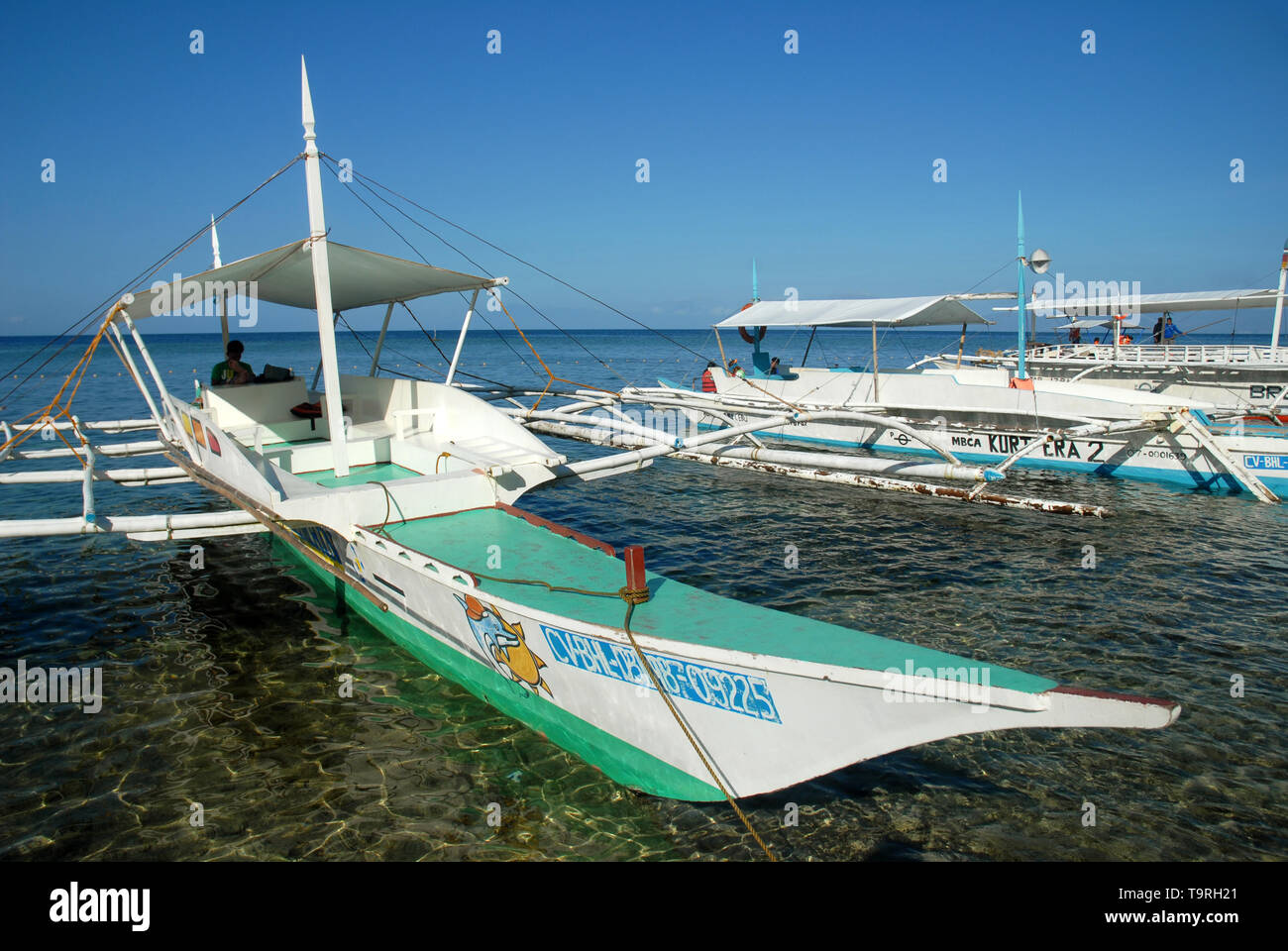 Bankas, traditional Philippine outrigger boats moored off the island of ...